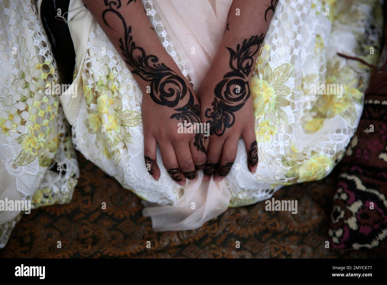 A Yemen girl displays her hands painted with henna as she attends Eid ...