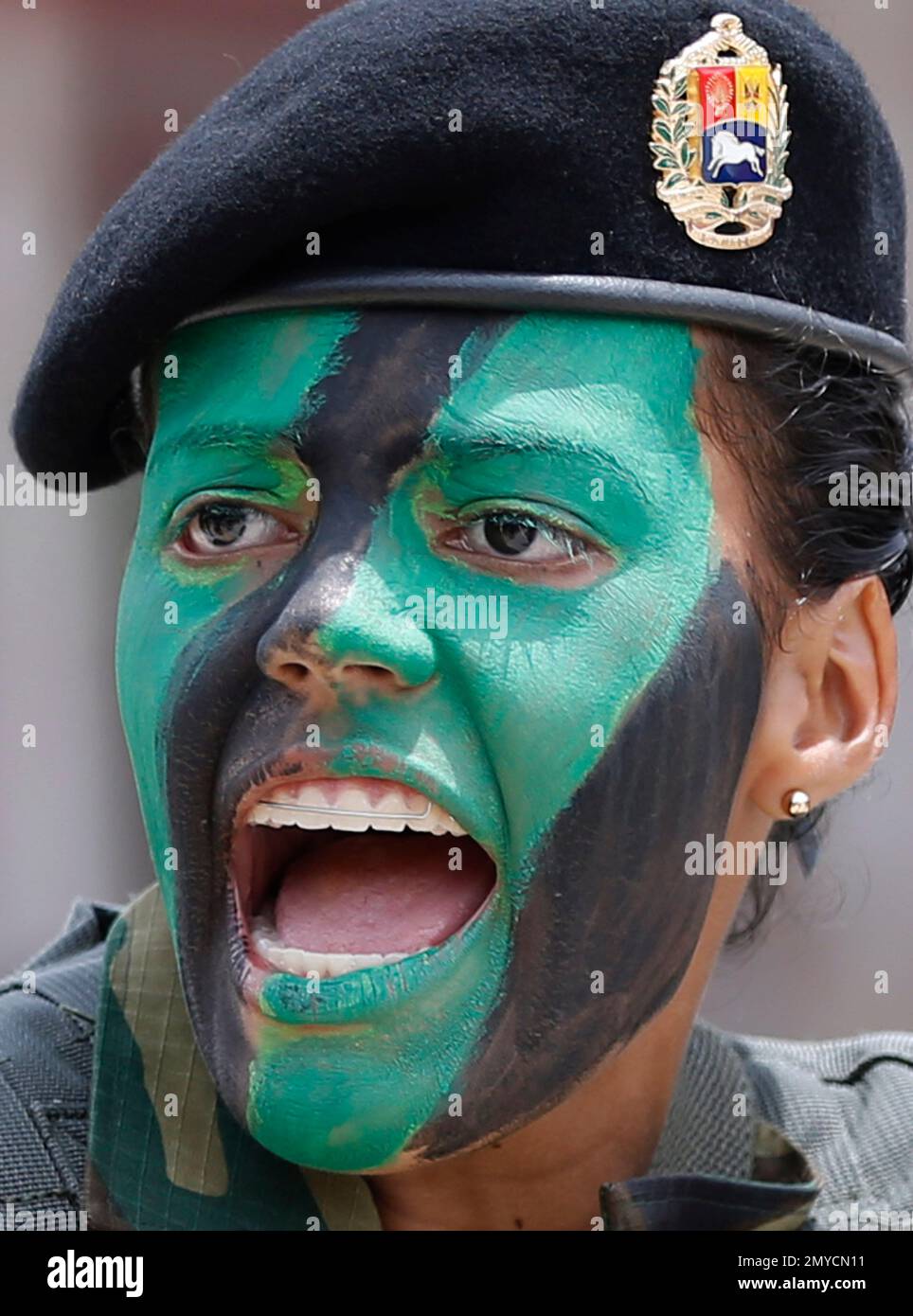 A female soldier marches during a parade marking Venezuela's ...