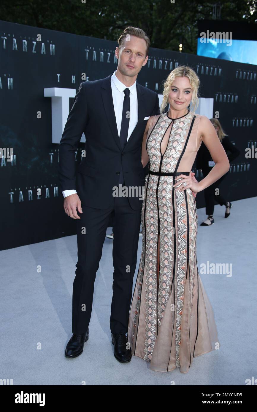 Actors Alexander Skarsgard, left, and Margot Robbie pose for ...