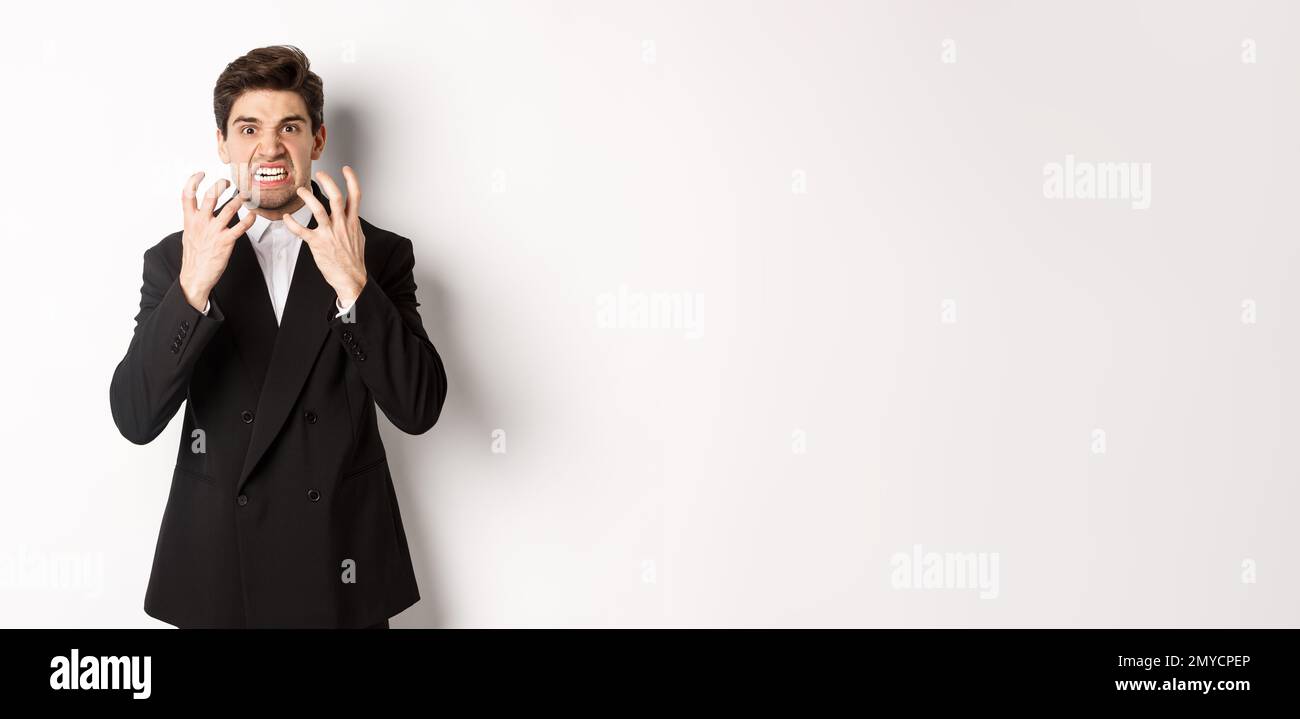 Image of angry businessman in suit, looking with furious expression and ...