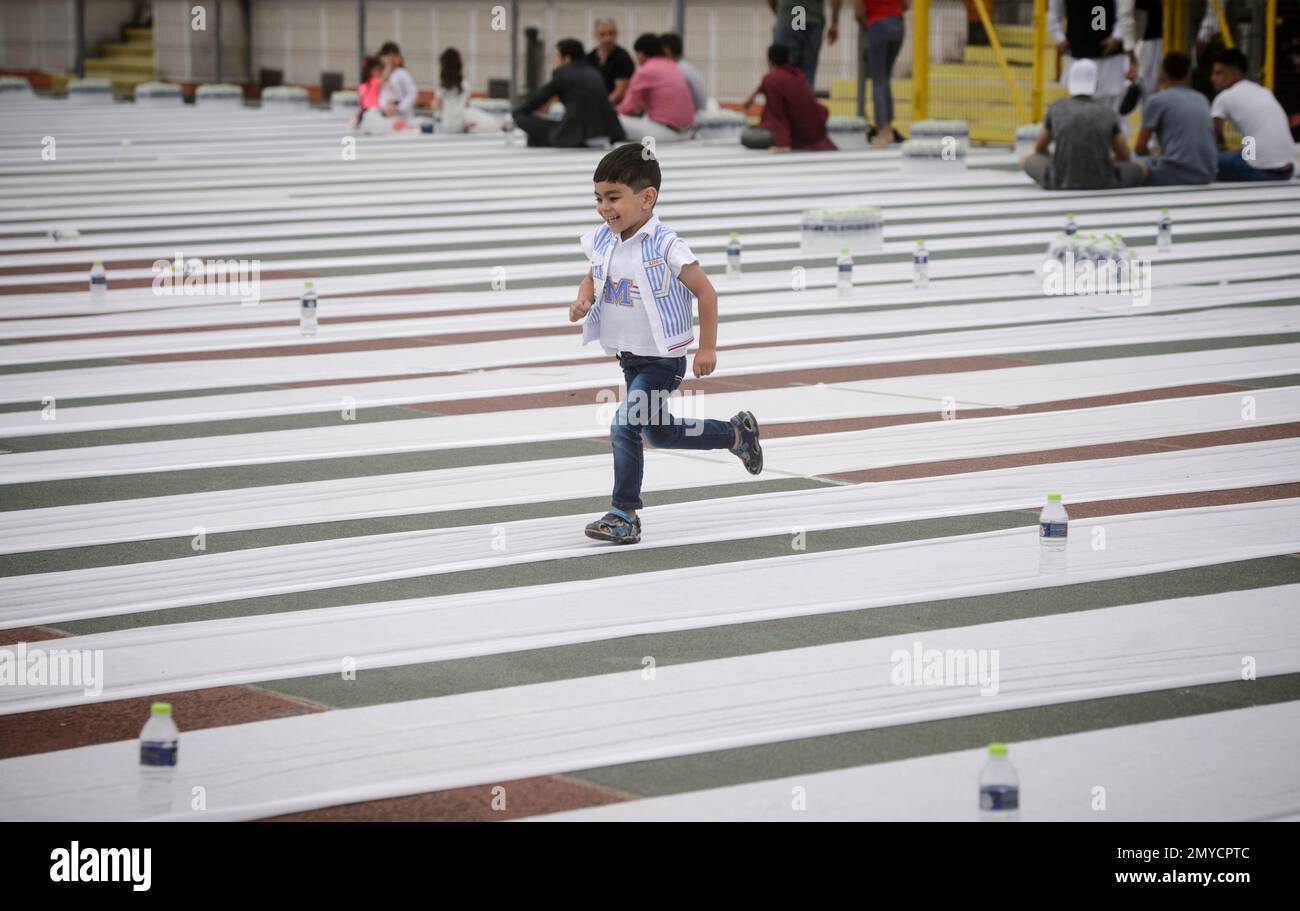 A Muslim boy runs on the athletics track after Eid al-Fitr prayers in ...