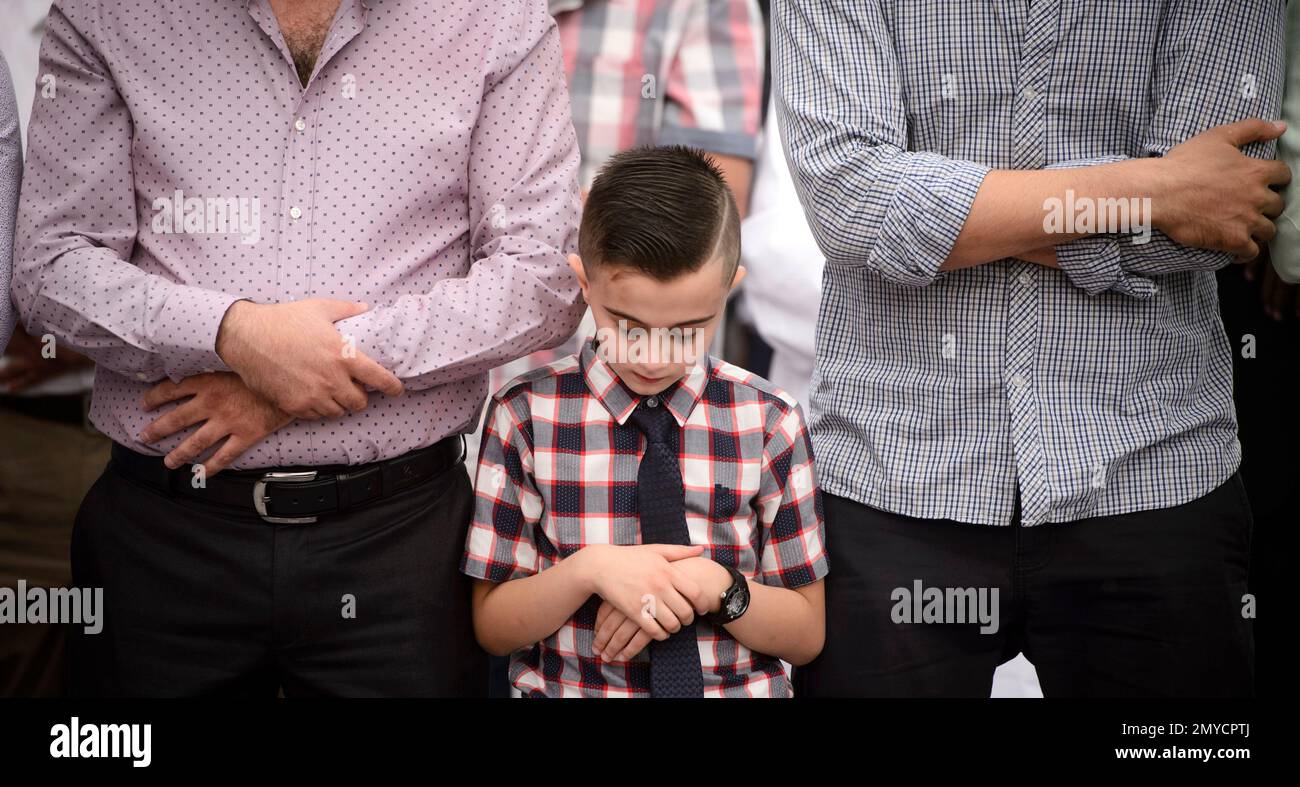 A Muslim boy takes part in Eid al-Fitr prayers in Bucharest, Romania ...