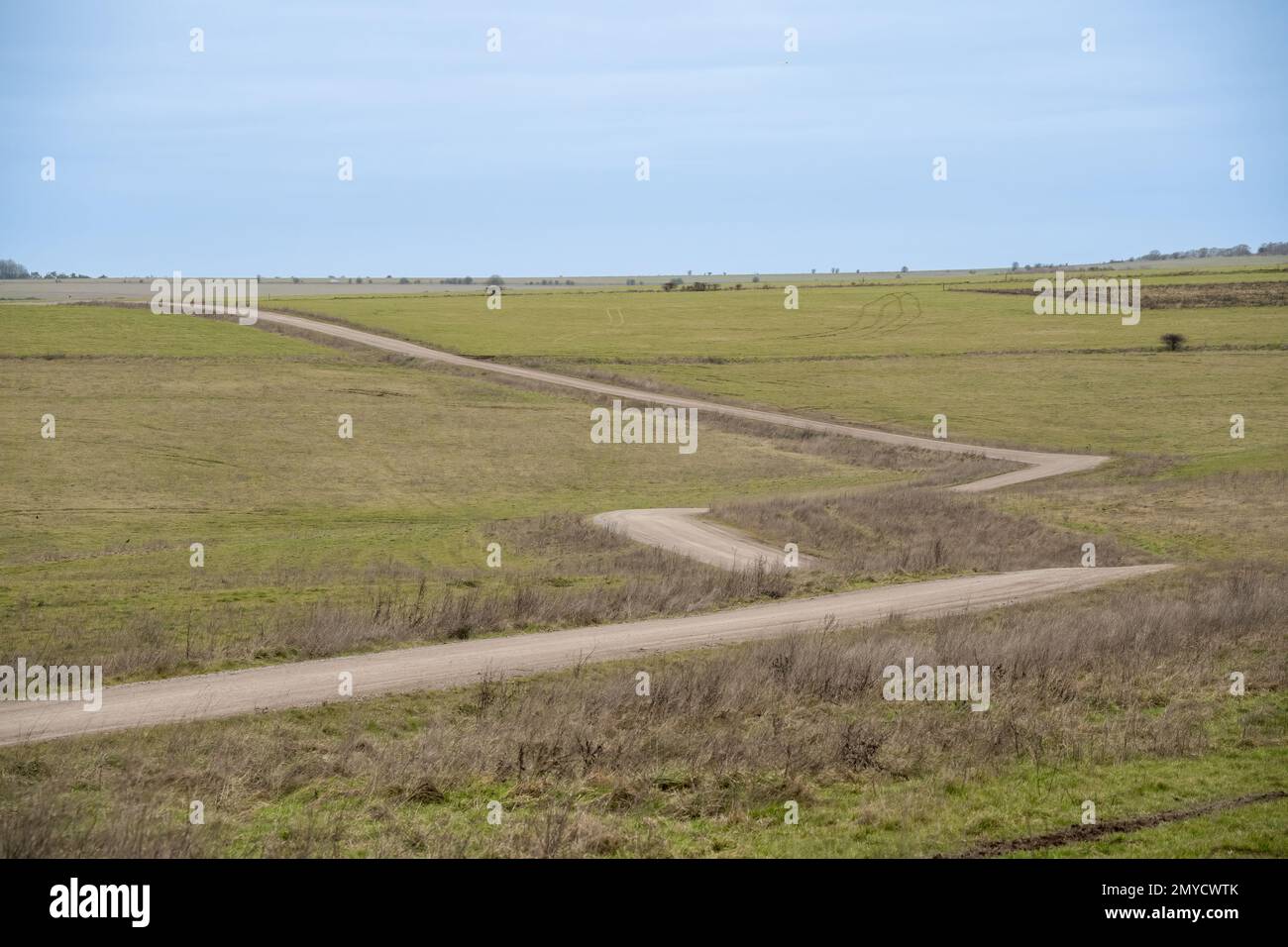a winding mud and stone track disappearing in to distant horizon ...