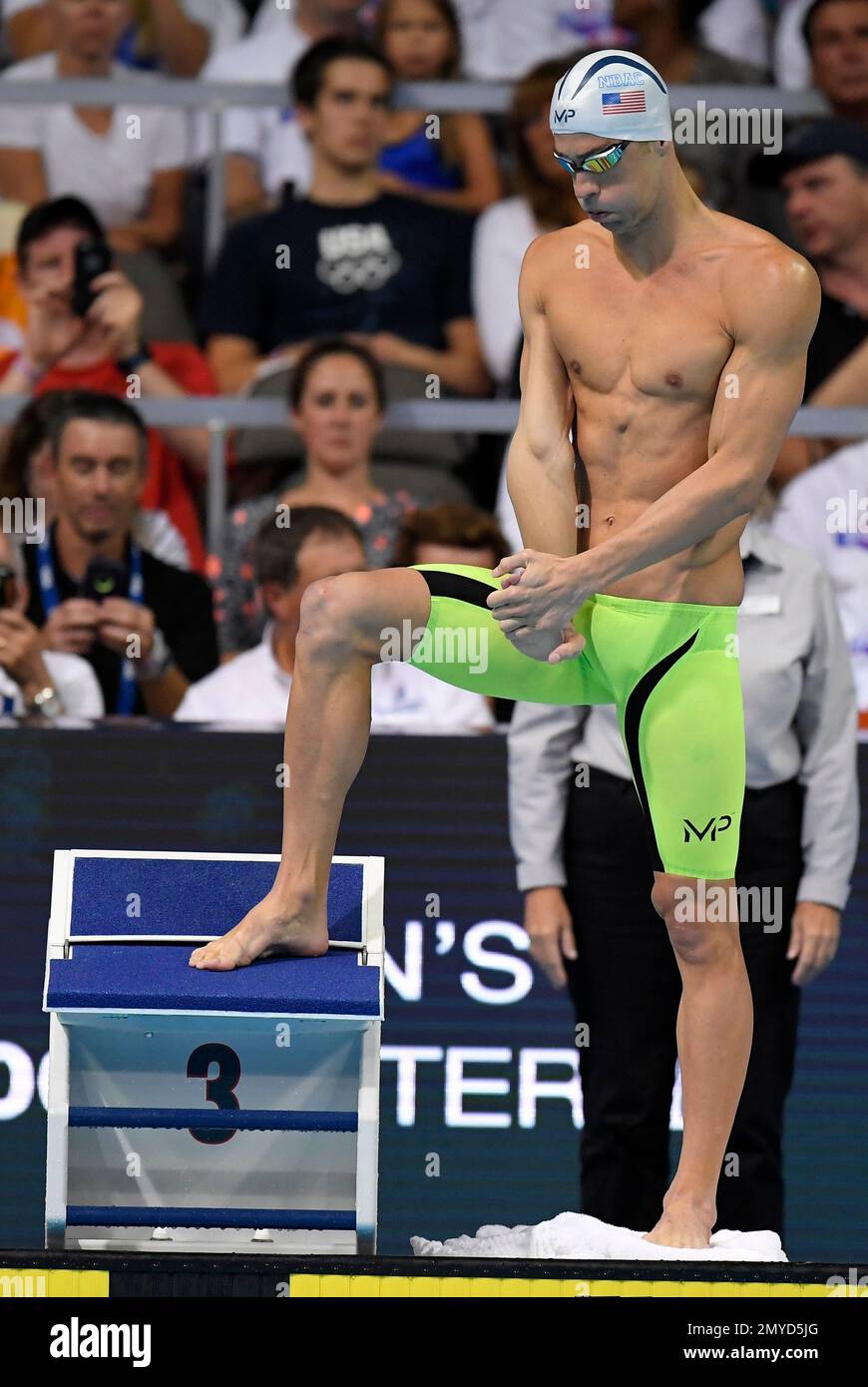 Michael Phelps waits for the start of his heat in the men's 100-meter ...