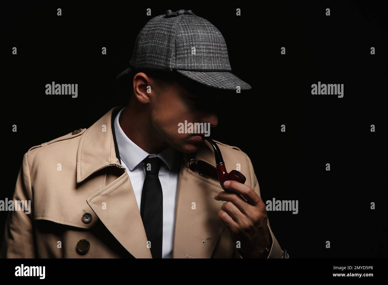 Old fashioned detective with smoking pipe on dark background Stock ...