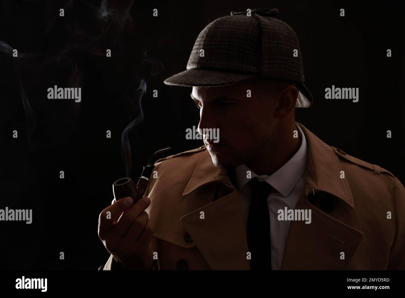 Old fashioned detective smoking pipe on dark background Stock Photo - Alamy