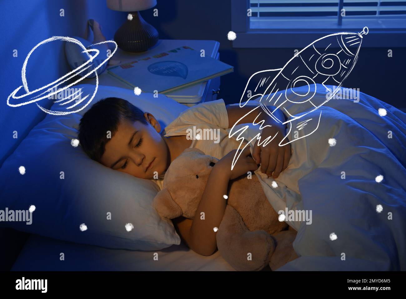 Sweet dreams. Cute little boy sleeping in bed. Spaceship, stars and ...