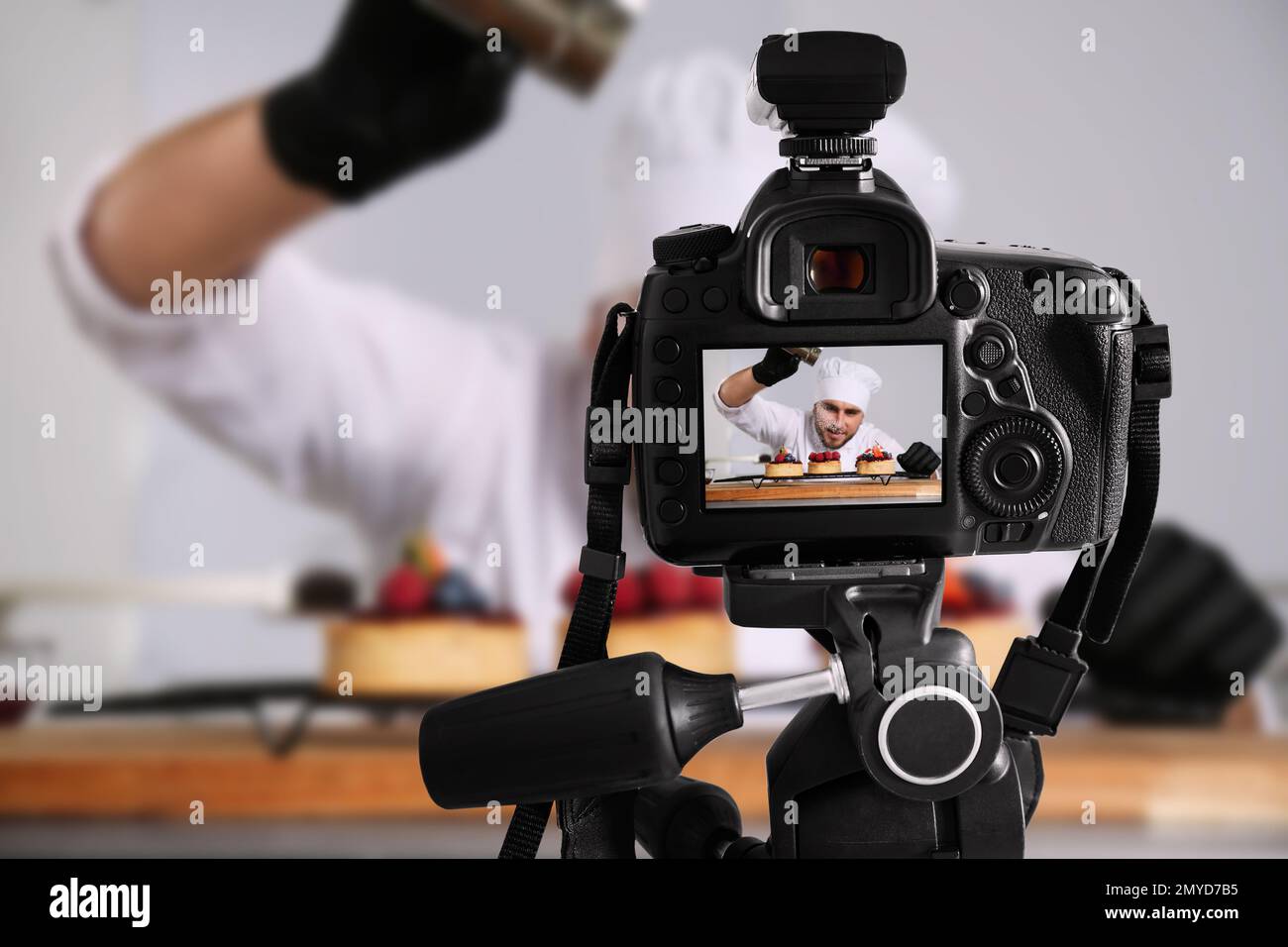 Food photography. Shooting of chef decorating desserts, focus on camera ...