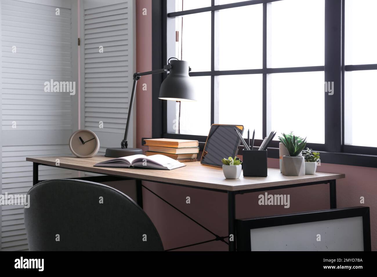 Stylish room interior with comfortable workplace near window Stock ...