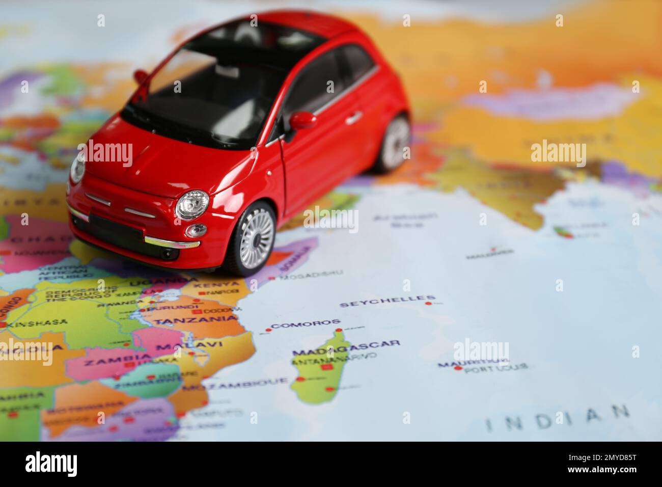 Red toy car on world map, closeup. Trip planning Stock Photo - Alamy