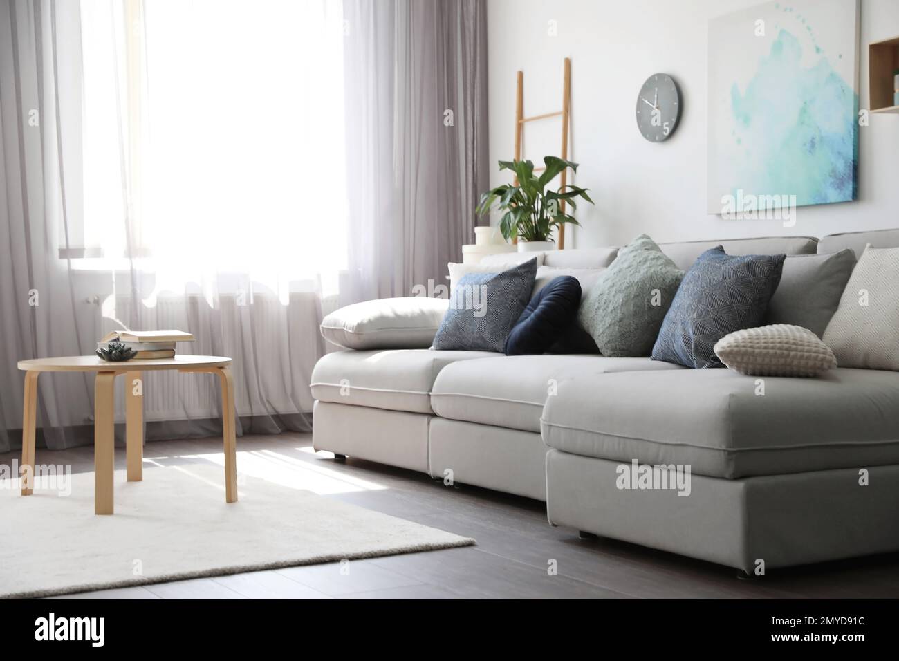 Elegant living room with comfortable sofa near window. Interior design ...