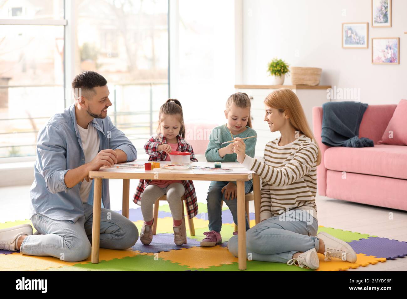 Lovely family painting at table indoors. Playing with children Stock ...