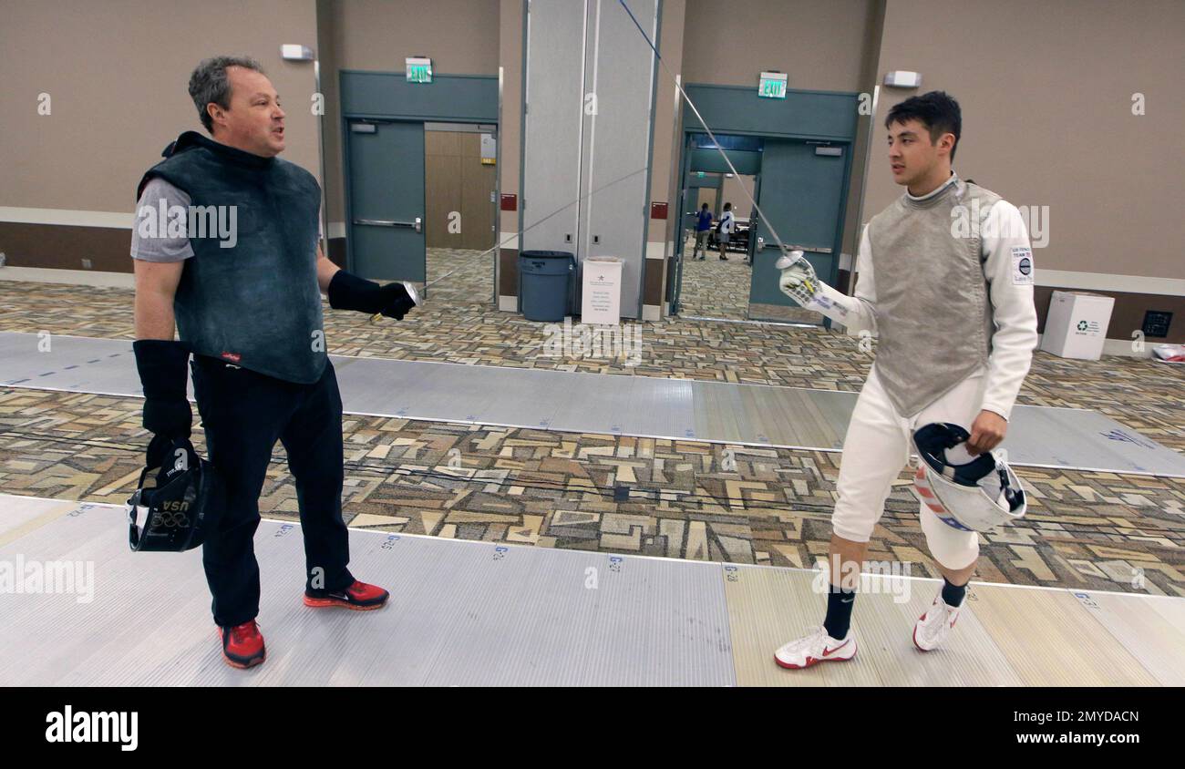 U.S. Olympic team fencer Alexander Massialas, right, listens to his ...