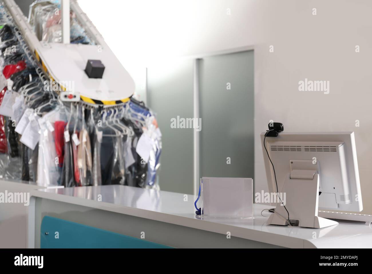 Modern dry-cleaner's interior with counter and garment conveyor Stock ...