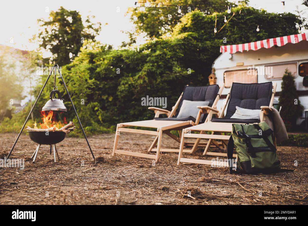 Water heating on open fire near trailer. Camping season Stock Photo - Alamy