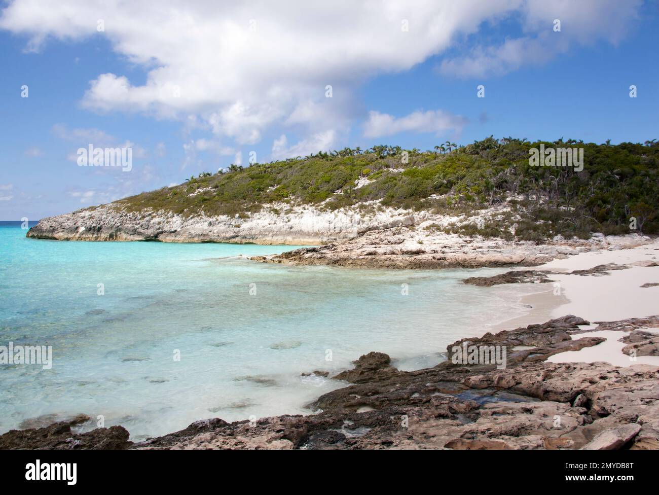 The scenic view of a small sandy beach surrounded by rocks on Half Moon ...