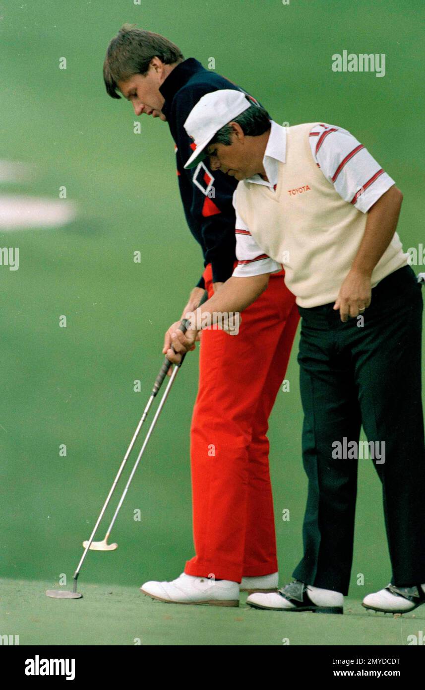 Masters co-leaders Lee Trevino and Nick Faldo repair ball marks on the ...