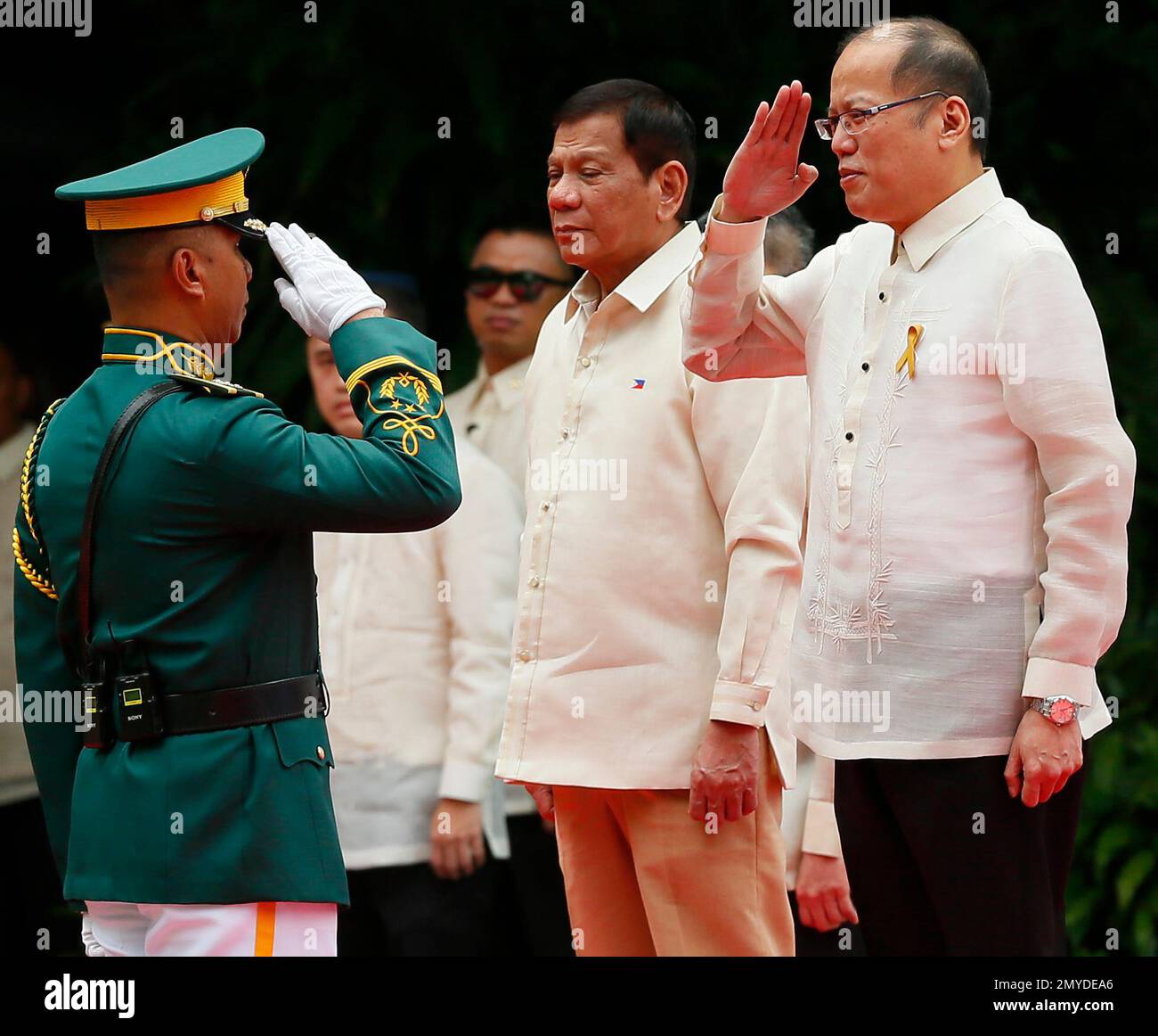 New Philippine President Rodrigo Duterte, center, stands at attention ...