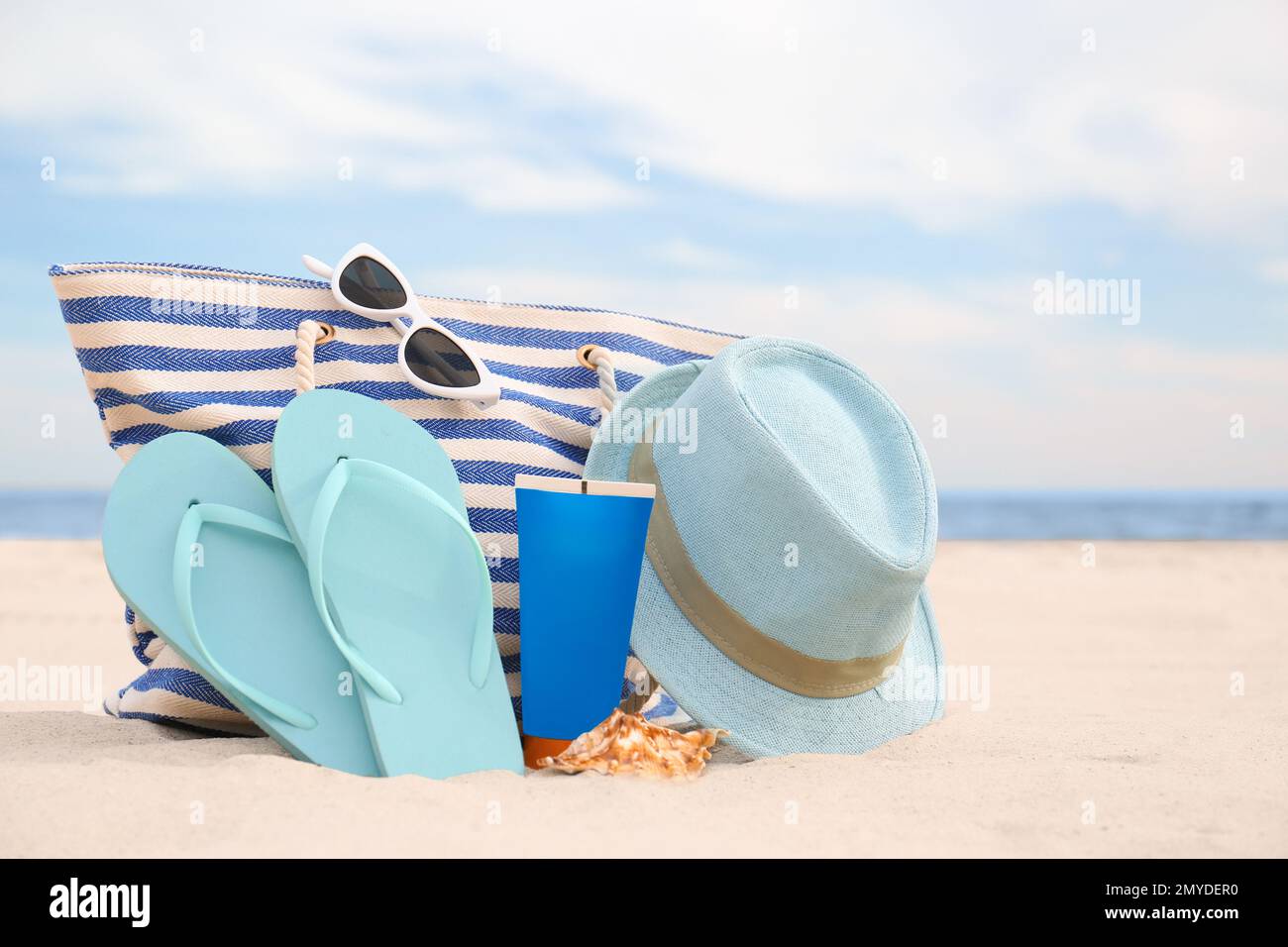 Different stylish beach objects on sand near sea Stock Photo - Alamy