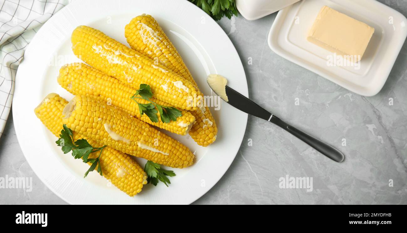 Tasty boiled corn cobs served on light grey marble table. Banner design ...