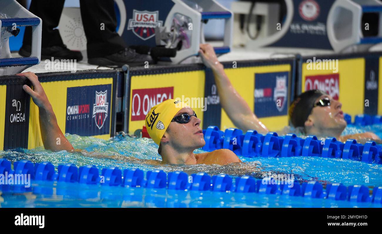 Josh Prenot, left, checks his time after swimming in the men's 200 ...