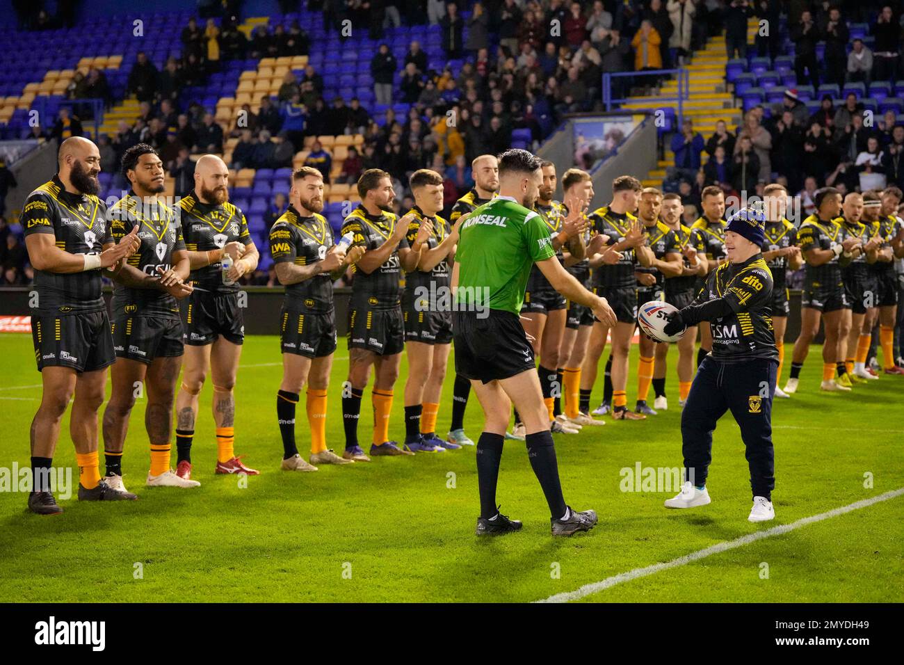 The match ball is delivered to the referee by a young fan before the ...