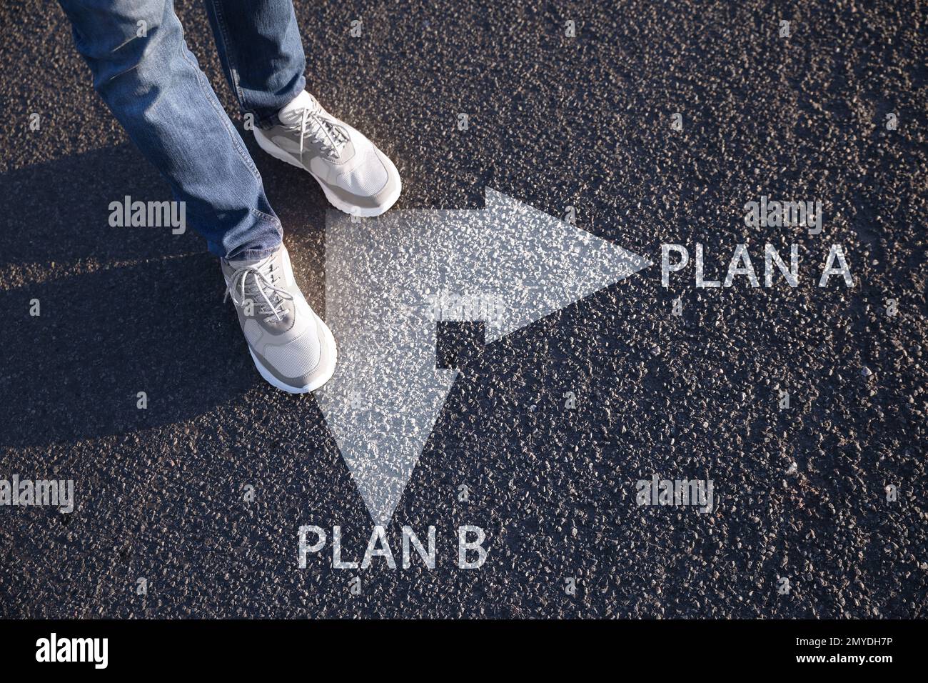 Choosing between Plan A and Plan B. Man near pointers on road, closeup ...