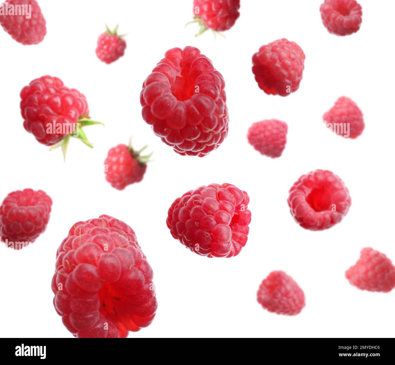 Fresh ripe raspberries falling on white background Stock Photo - Alamy