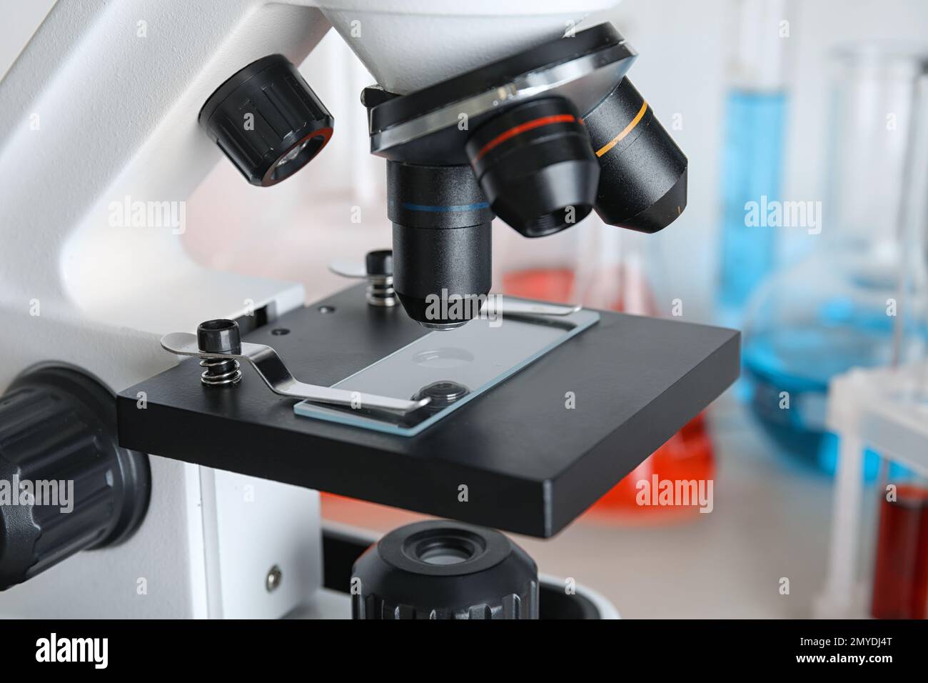Microscope with glass slide on table, closeup. Laboratory analysis ...