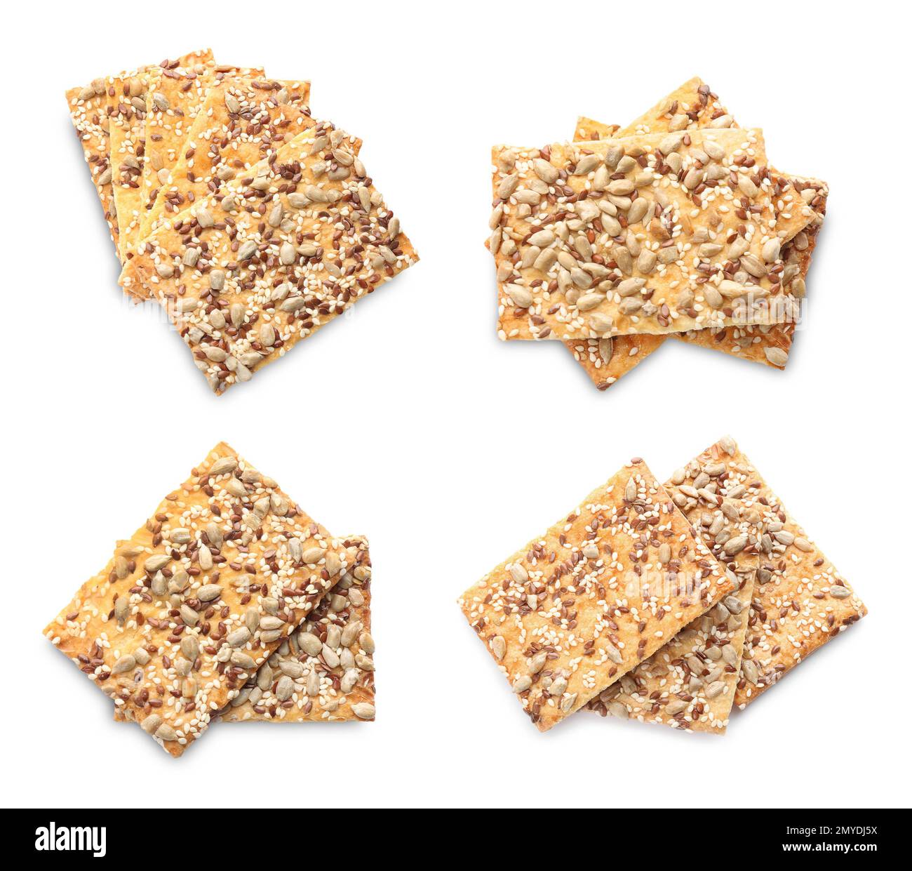 Set of tasty crispy crackers with different seeds on white background ...