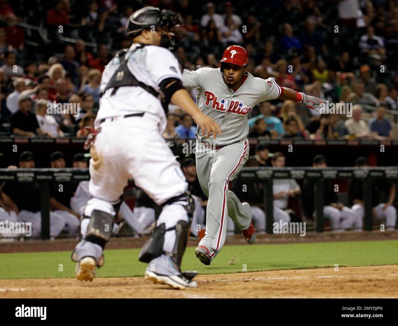Philadelphia Phillies' Jimmy Paredes (41) heads home to tie the score ...