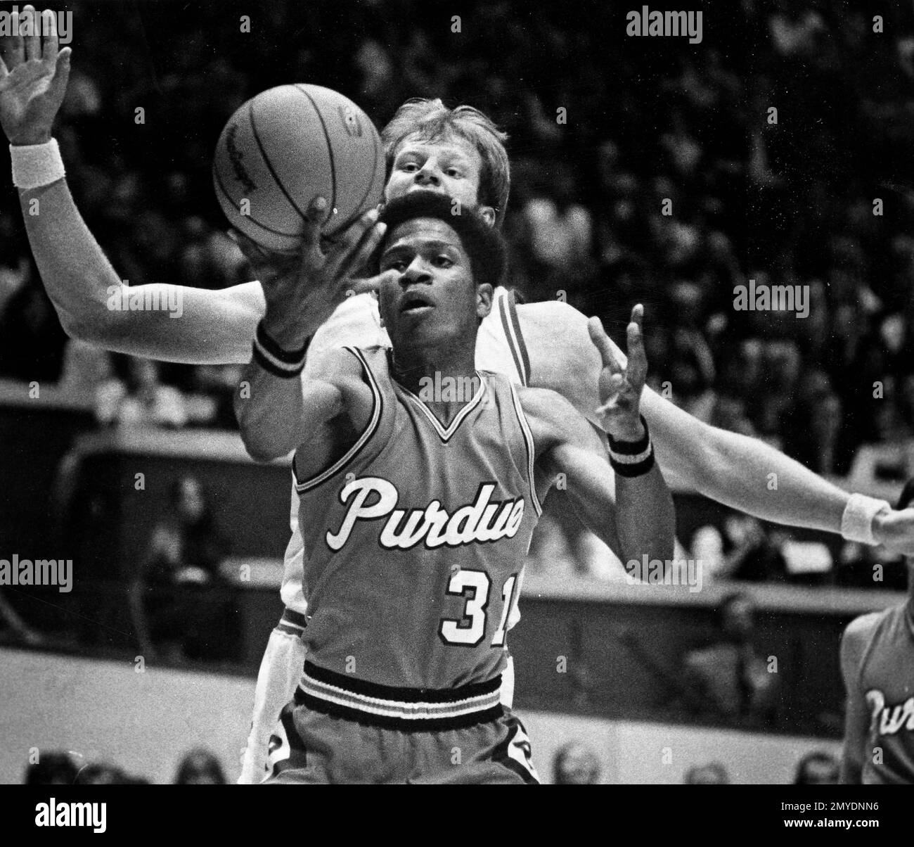 Indiana center Kent Benson looks over the shoulder of Gerald Thomas of ...