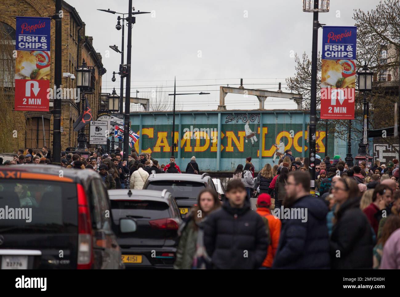 Camden Lock bridge and High Street tourists at Camden Market London ...