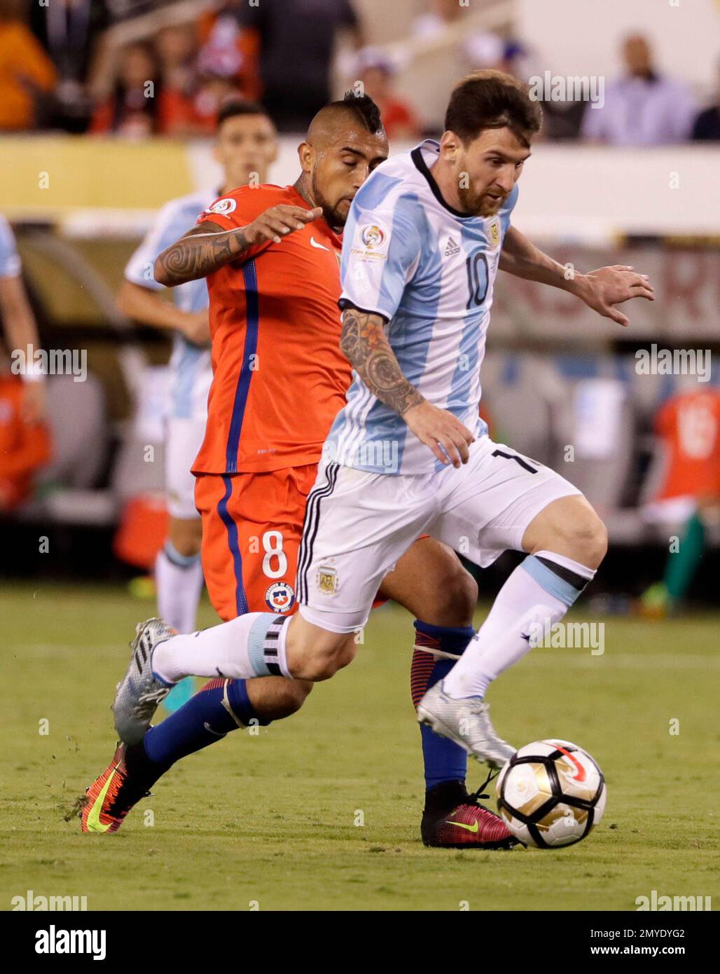 Argentina's Lionel Messi (10) is defended by Chile's Arturo Vidal during the second half of the ...