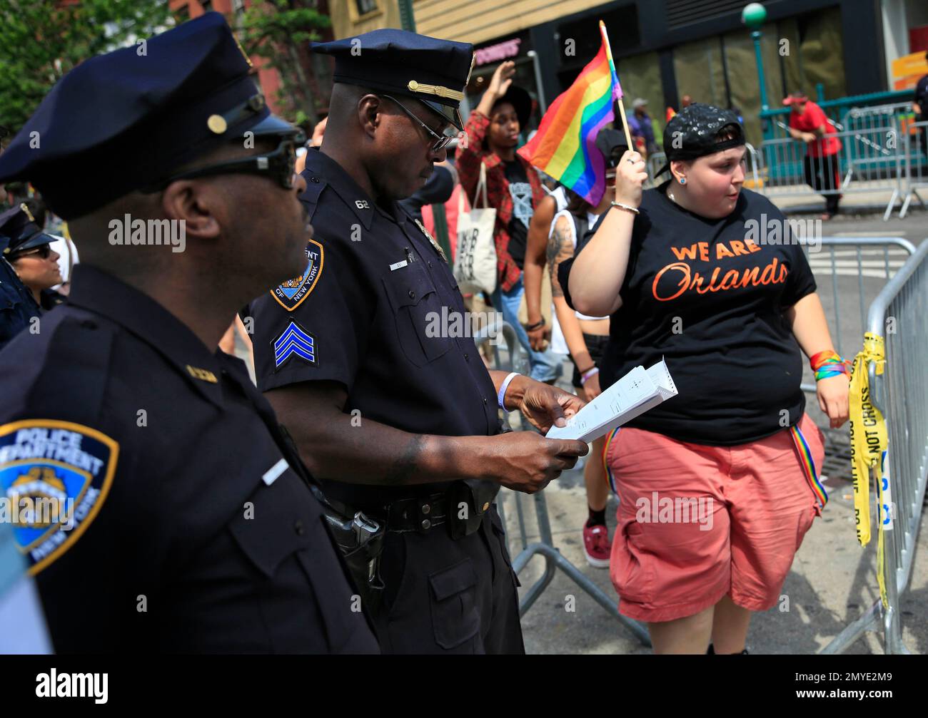 Police officers stand along the route of the NYC Pride Parade in New ...