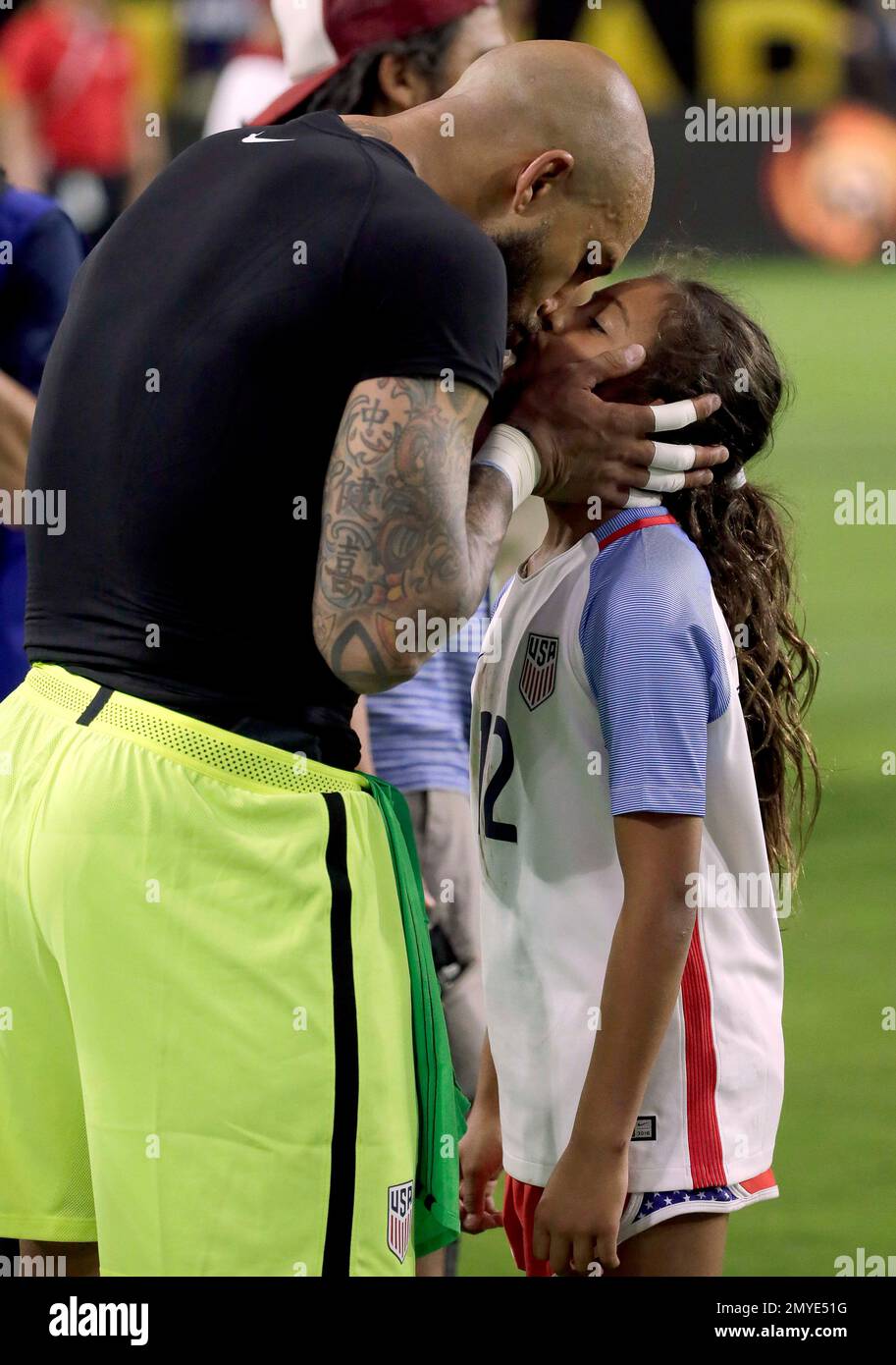 United States goalkeeper Tim Howard kisses his daughter, Alivia Howard ...