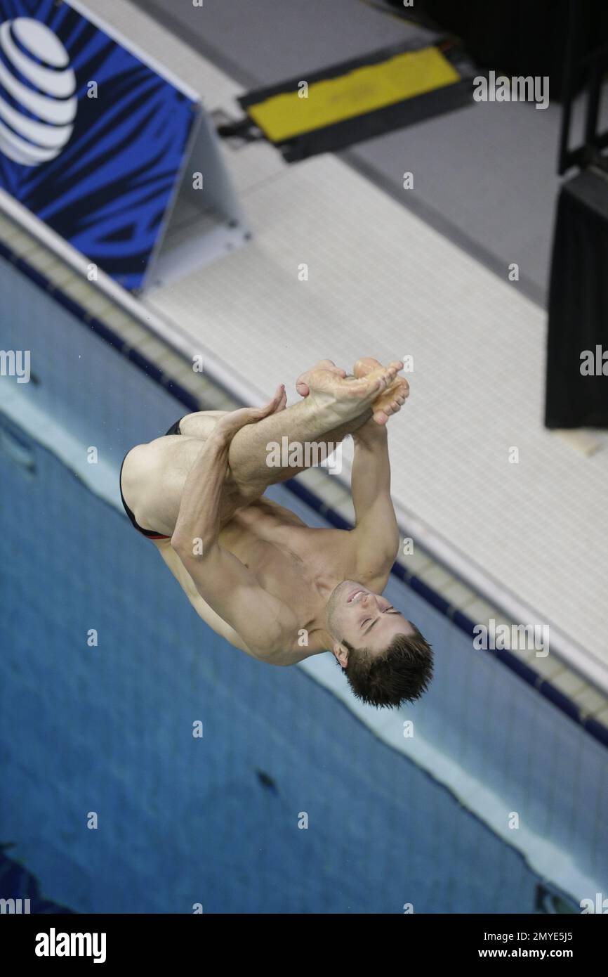 Michael Hixon performs a dive during the men's 3-meter springboard ...