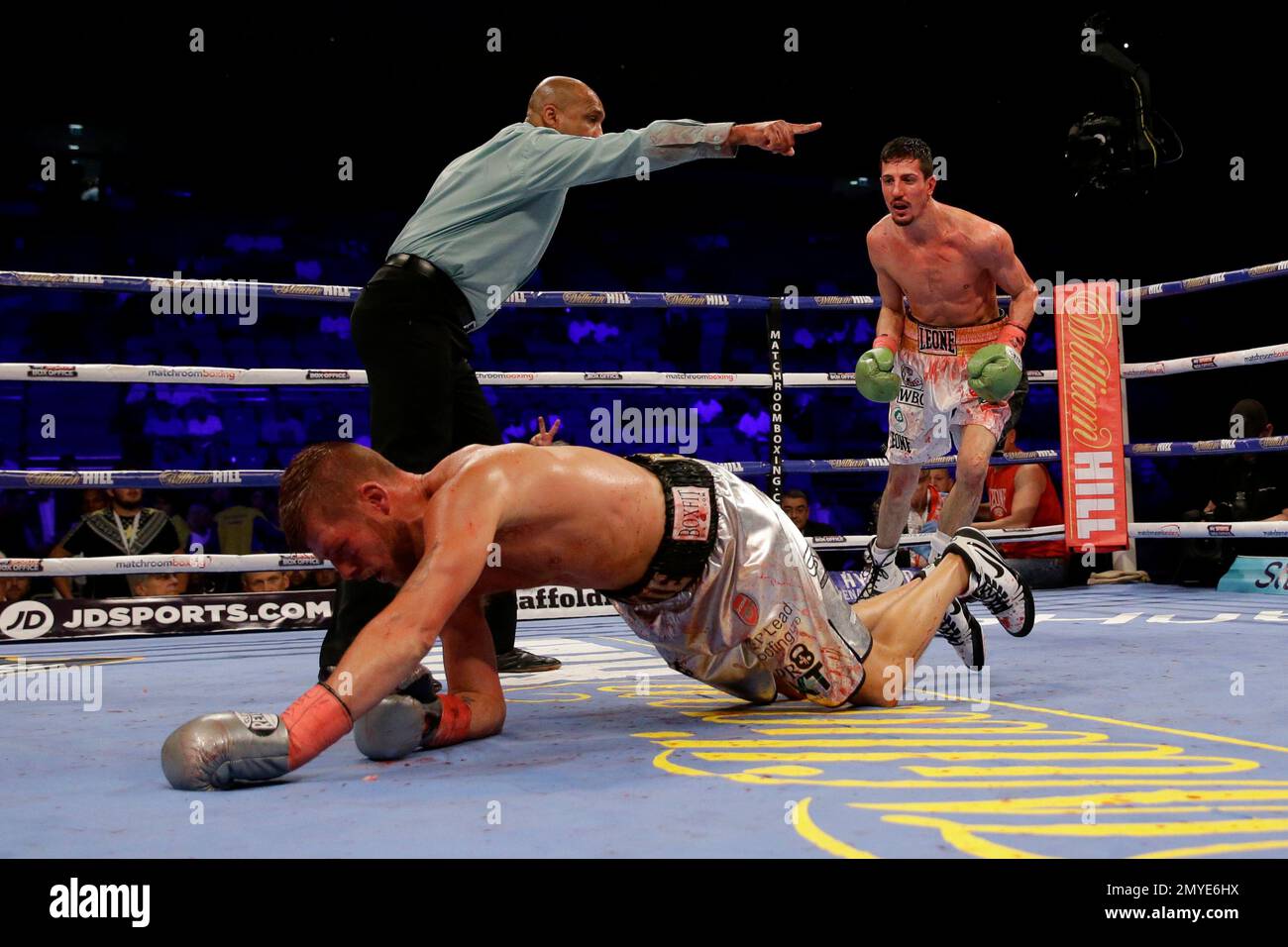 Italian boxer Andrea Scarpa, right, watches after knocking down British boxer John Wayne Hibbert ...