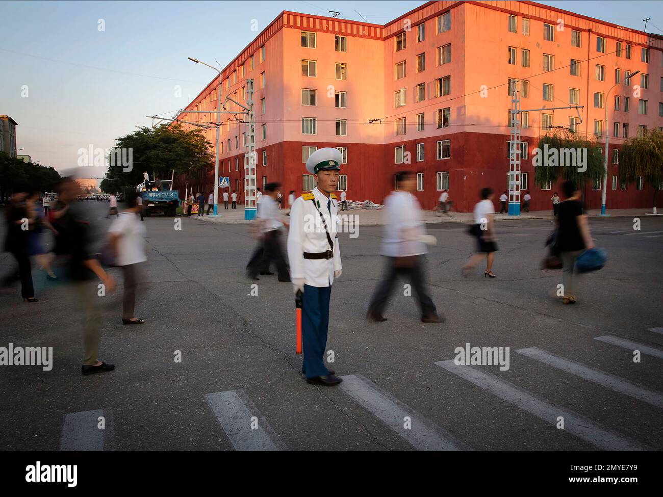 A North Korean traffic policeman directs pedestrians leaving an anti-U ...