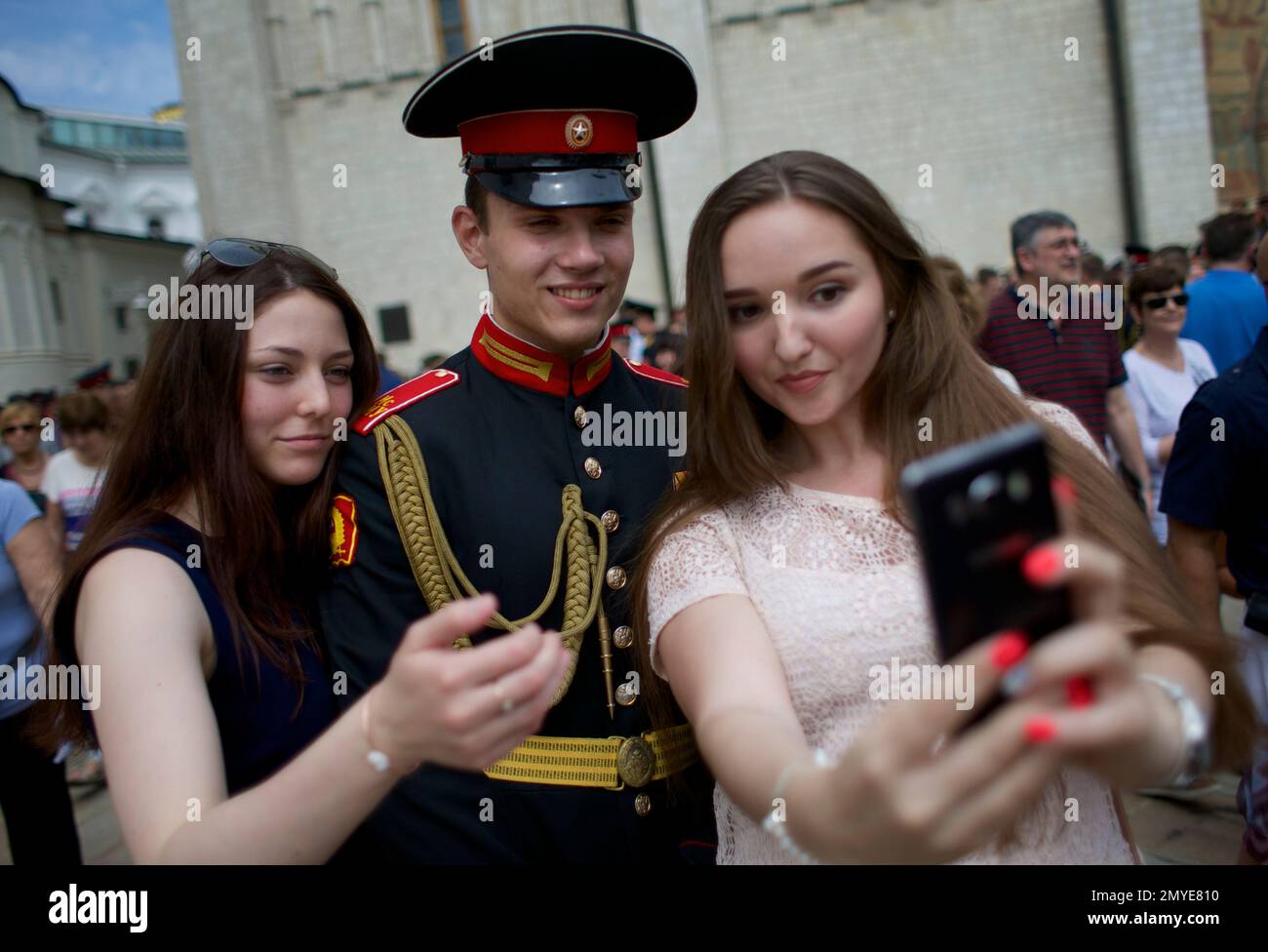 Russian girls take photos with a cadet after a graduation ceremony in ...