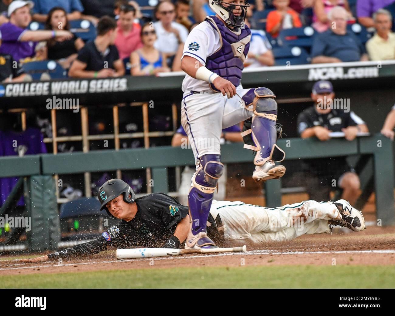 Coastal Carolina's Anthony Marks, bottom, scores behind TCU catcher ...