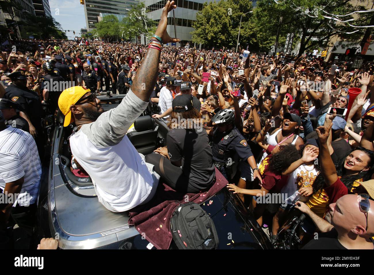 Cleveland Cavaliers' LeBron James, center, takes video of the crowd as ...
