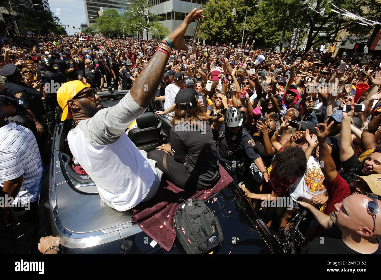 Cleveland Cavaliers' LeBron James, center, takes video of the crowd as ...