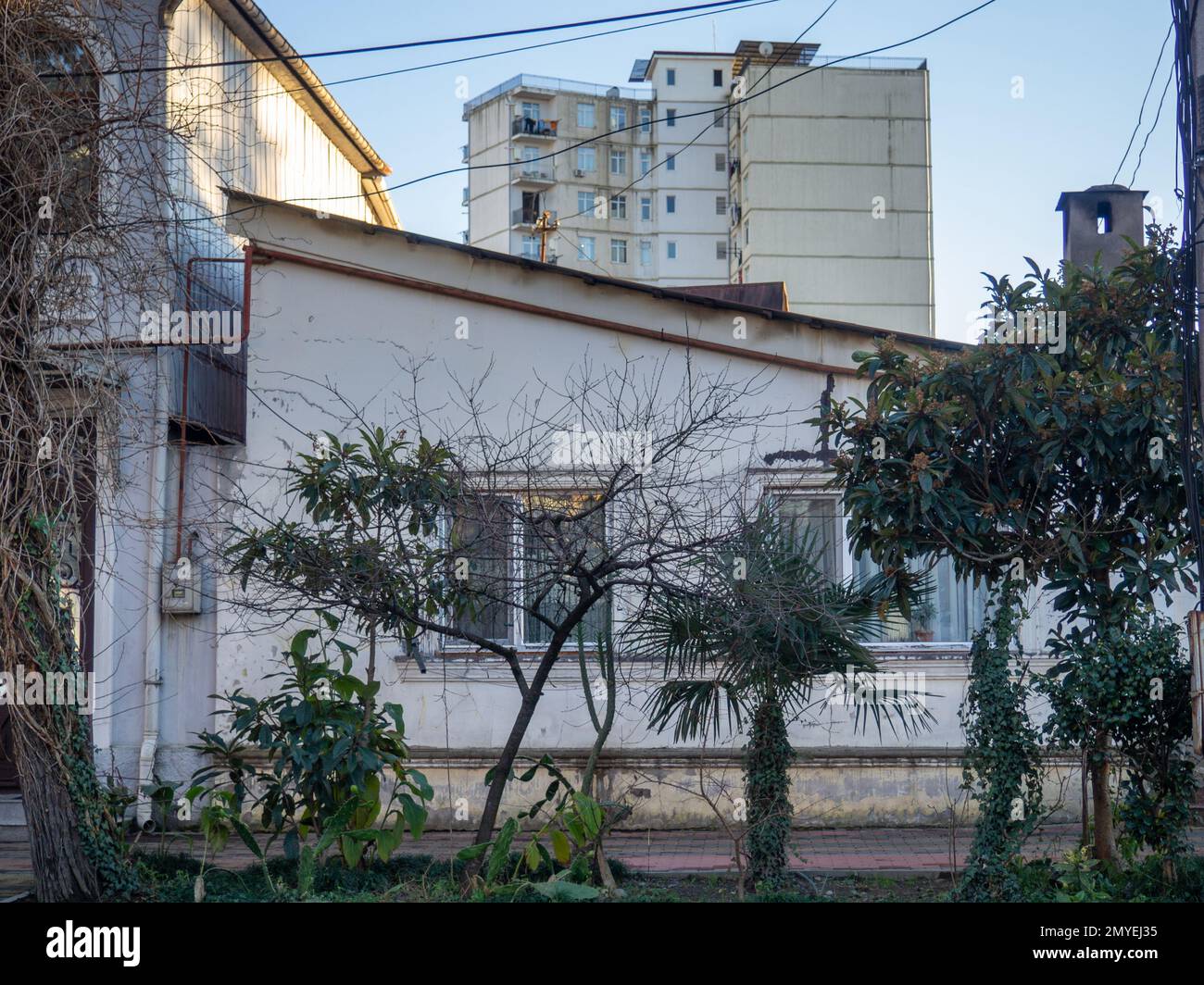 Backyard in the old area. Facade of an old house. Shabby walls of the ...