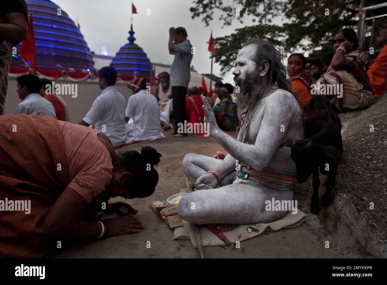 A Hindu holy man who has smeared his body with sacred ash gives ...
