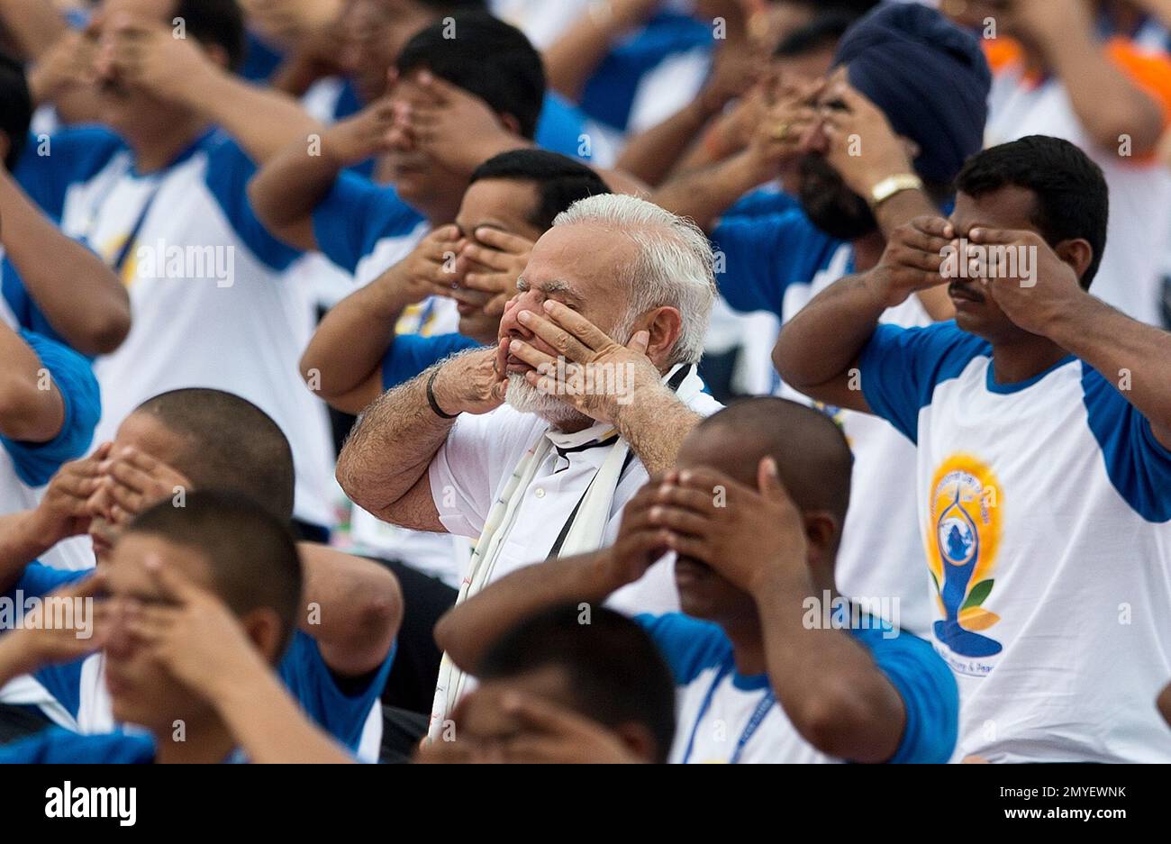 Indian Prime Minister Narendra Modi performs yoga along with others in ...