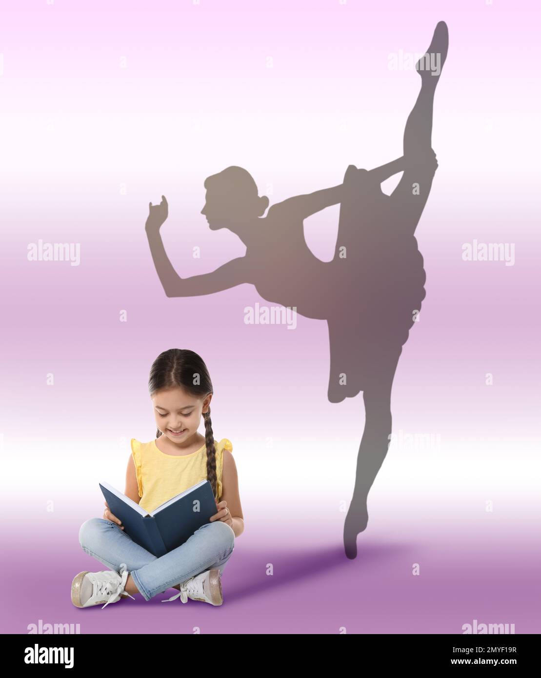 Cute little girl with book dreaming to be ballet dancer. Silhouette of ...