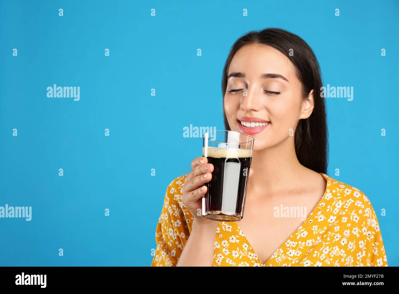 Beautiful woman with cold kvass on blue background. Traditional Russian ...