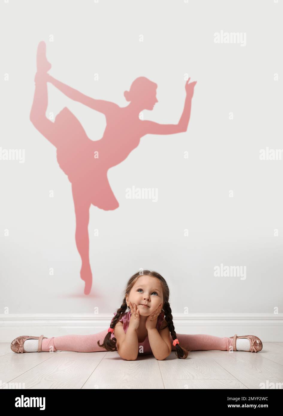 Cute little girl dreaming to be ballet dancer. Silhouette of woman ...