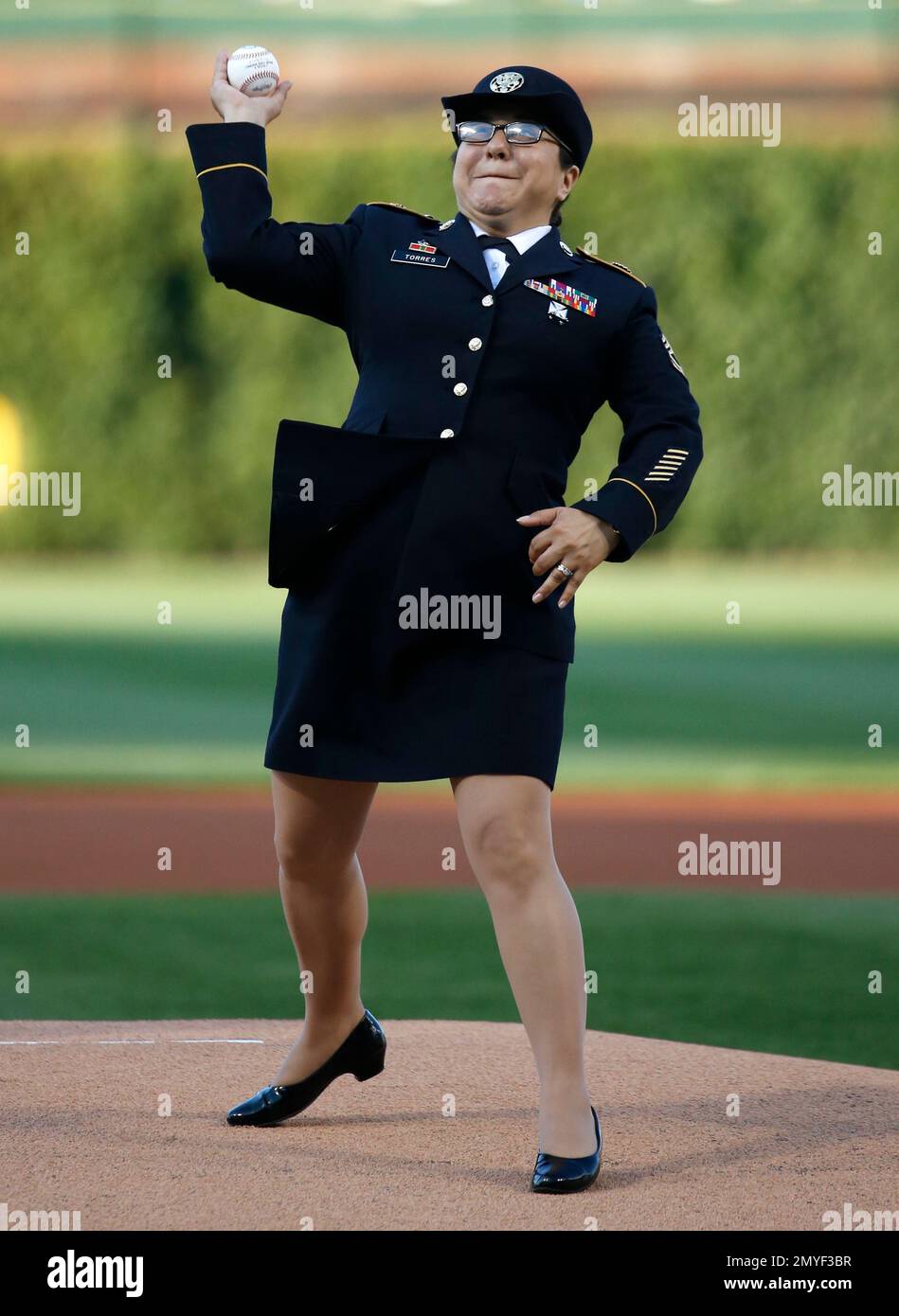 Army SFC Susan Torres throws out a ceremonial first pitch before a ...